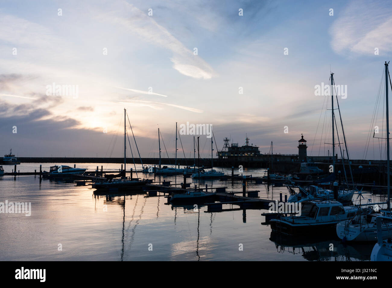 England, Ramsgate harbour. Sunrise over cloud layer on horizon ...