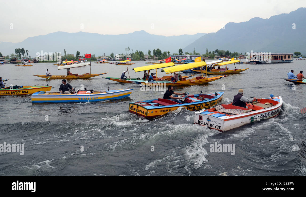 Srinagar, Kashmir. 2nd May, 2017. Kashmiri men row boats and drive ...