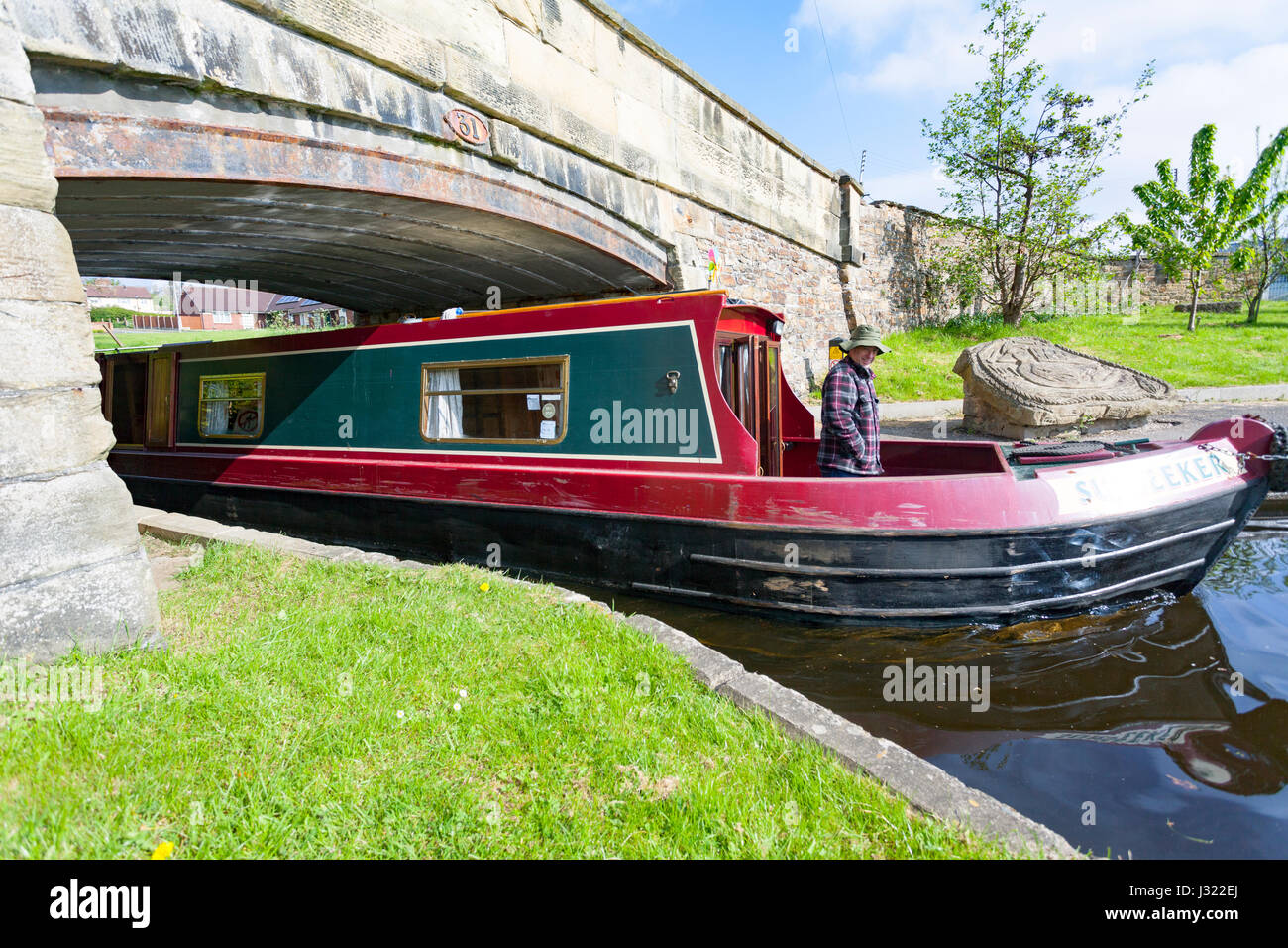 People coming through a bridge into Trevor Basin on the Llangollen ...