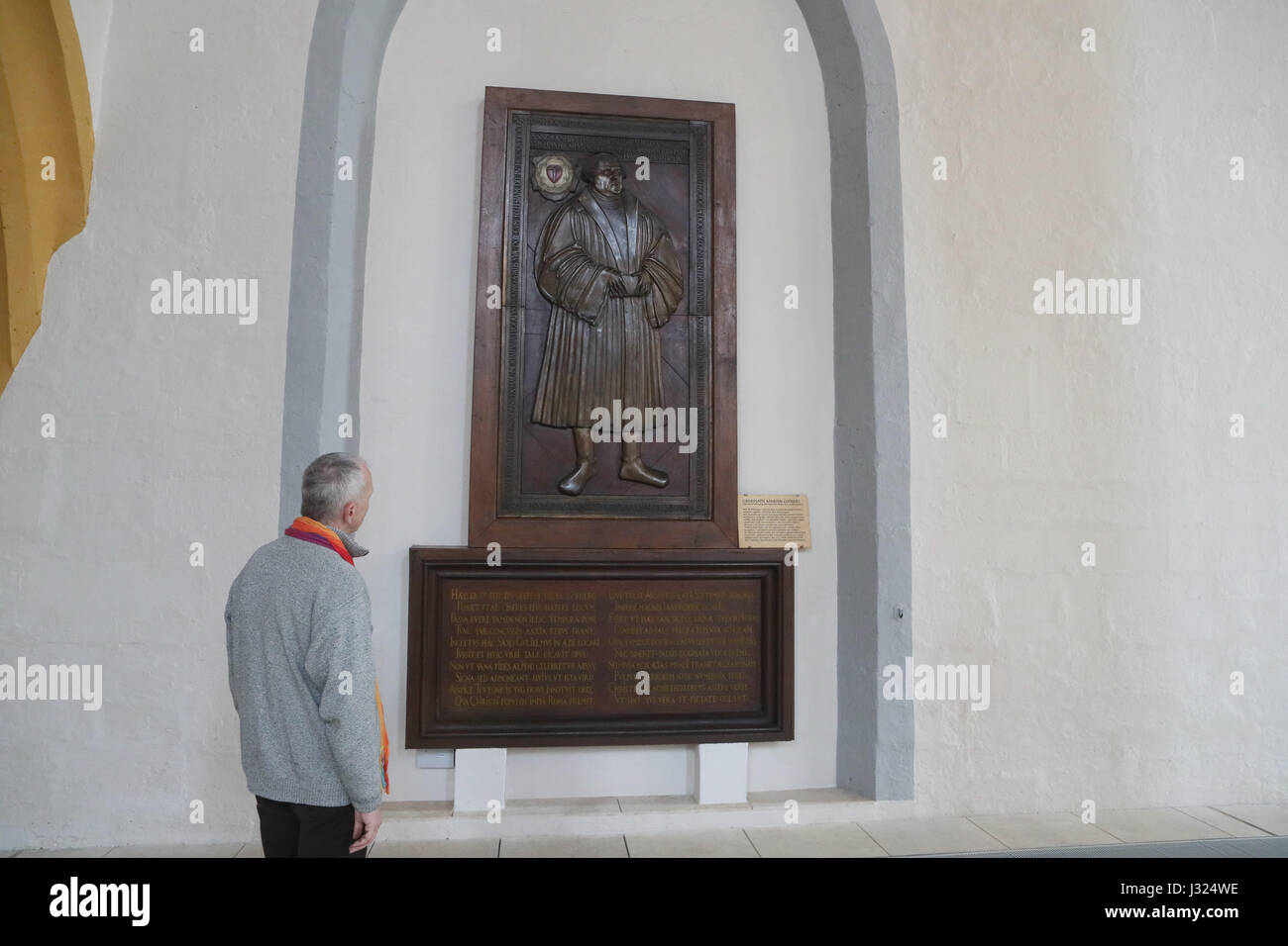 A visitor stands in front of the tomb slab of Martin Luther at the St ...