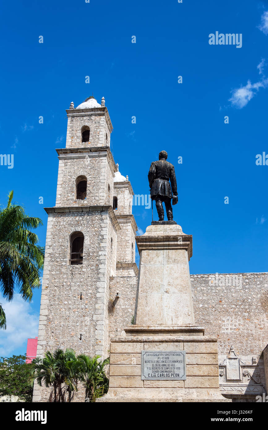 Statue and Jesuit church in the center of Merida, Mexico Stock Photo ...