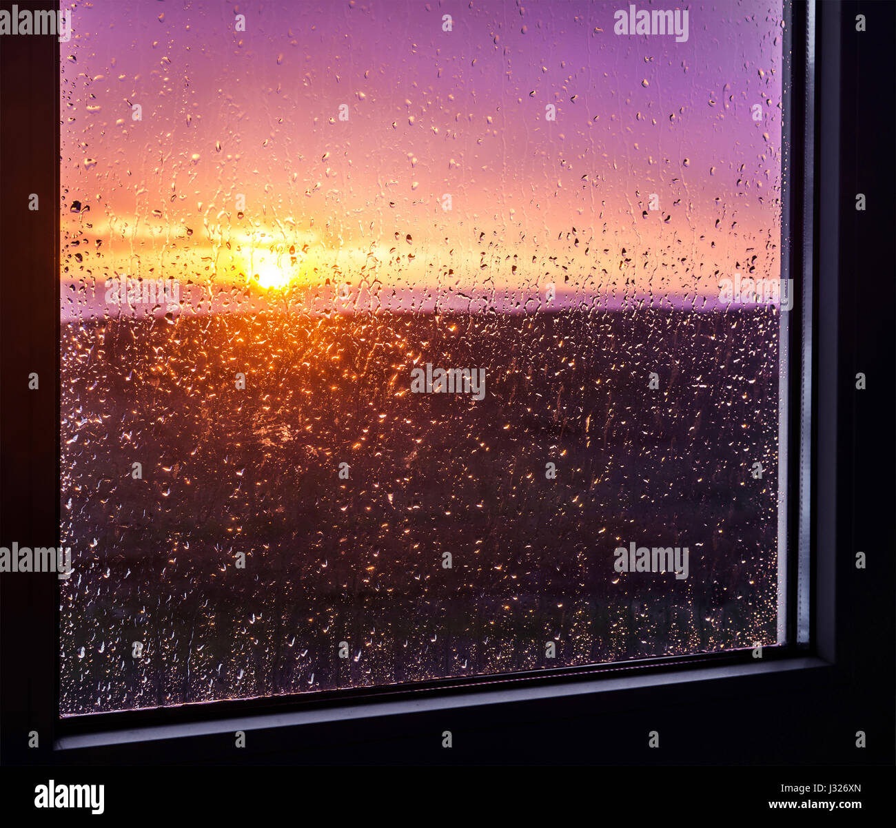 rainy sunset in window Stock Photo - Alamy