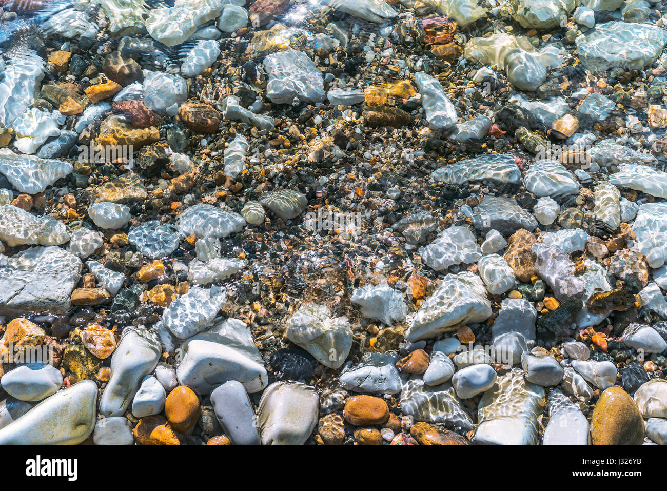 rubble pebble rocks in the clear water Stock Photo - Alamy