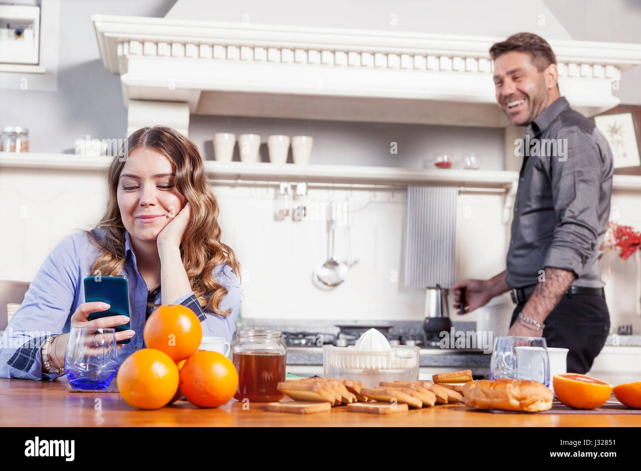 beautiful husband prepares breakfast for a bored wife Stock Photo - Alamy