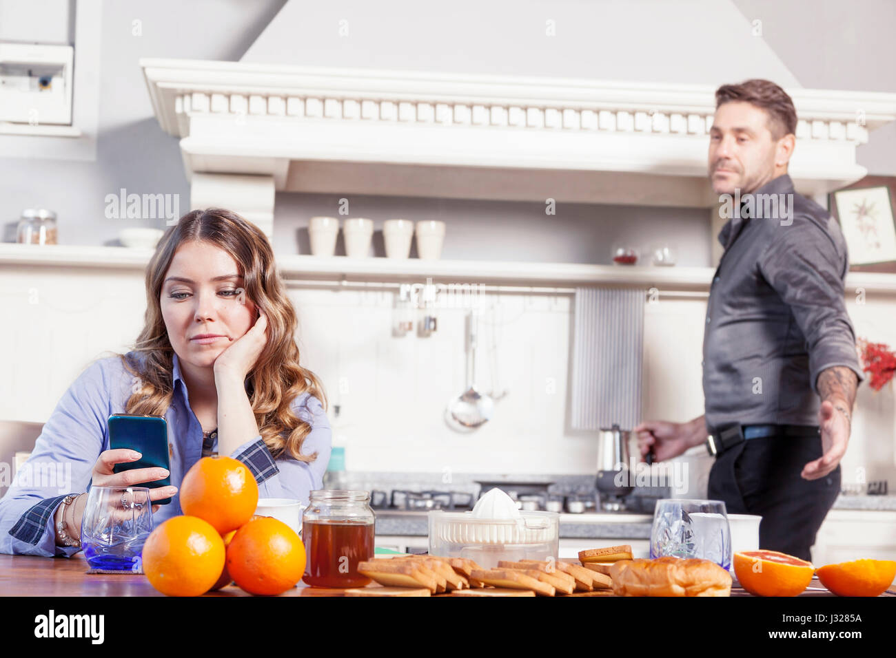Two people looking at phone angry hi-res stock photography and images ...