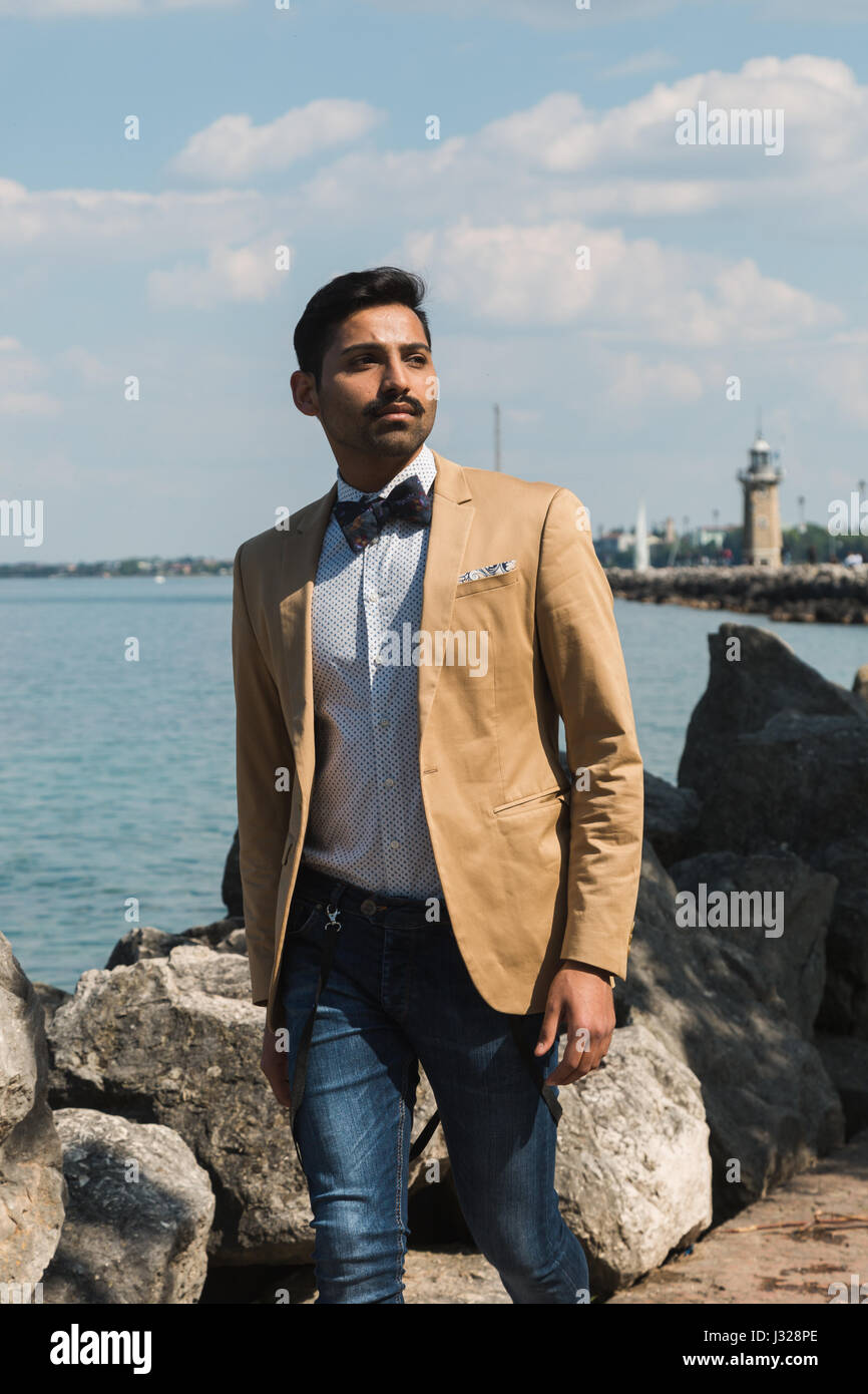 Handsome Indian man posing in a vacation context. Street fashion and ...
