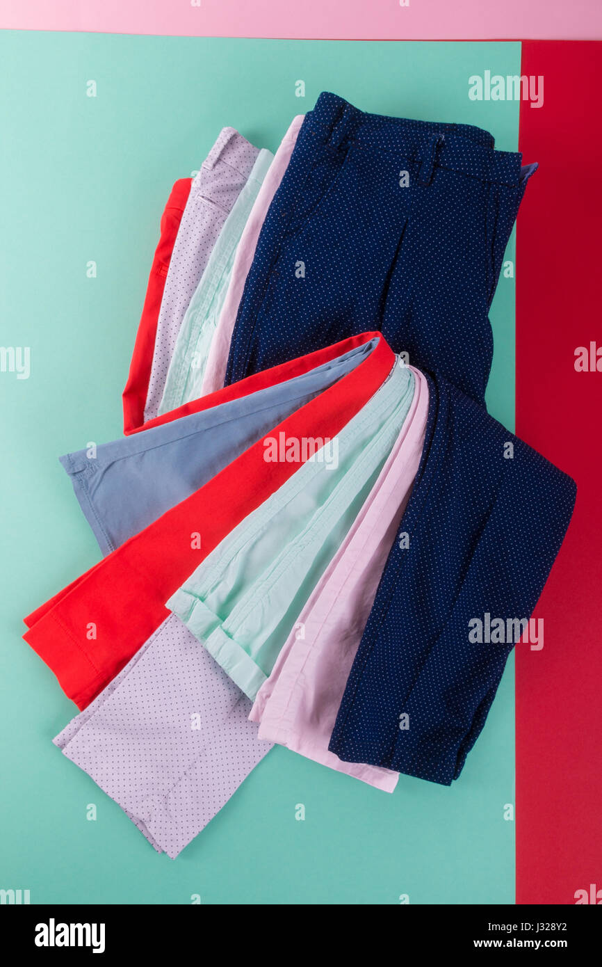 Folded colorful pants and jeans. Top view Stock Photo - Alamy