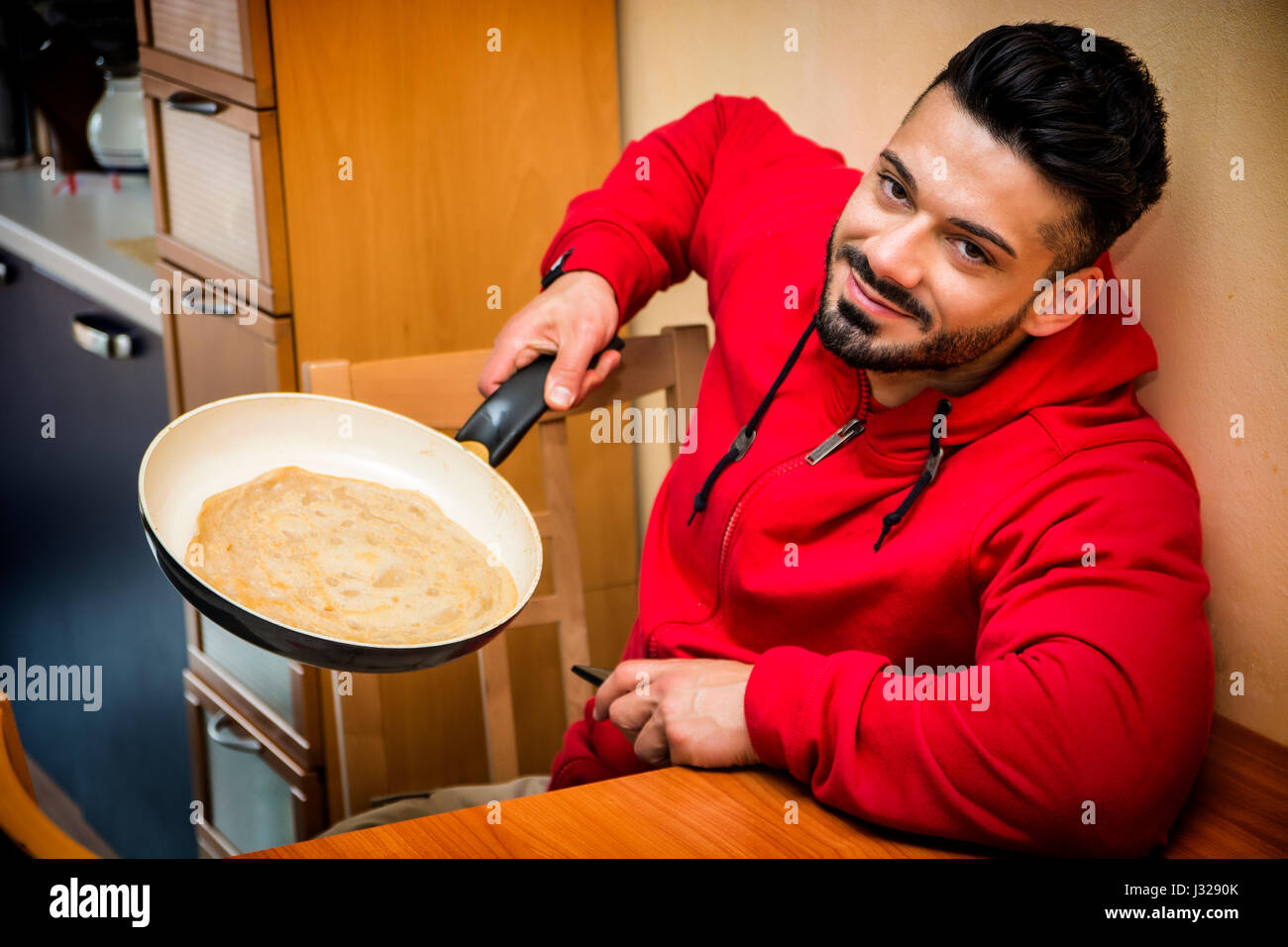 Man holding pan with pancake Stock Photo - Alamy