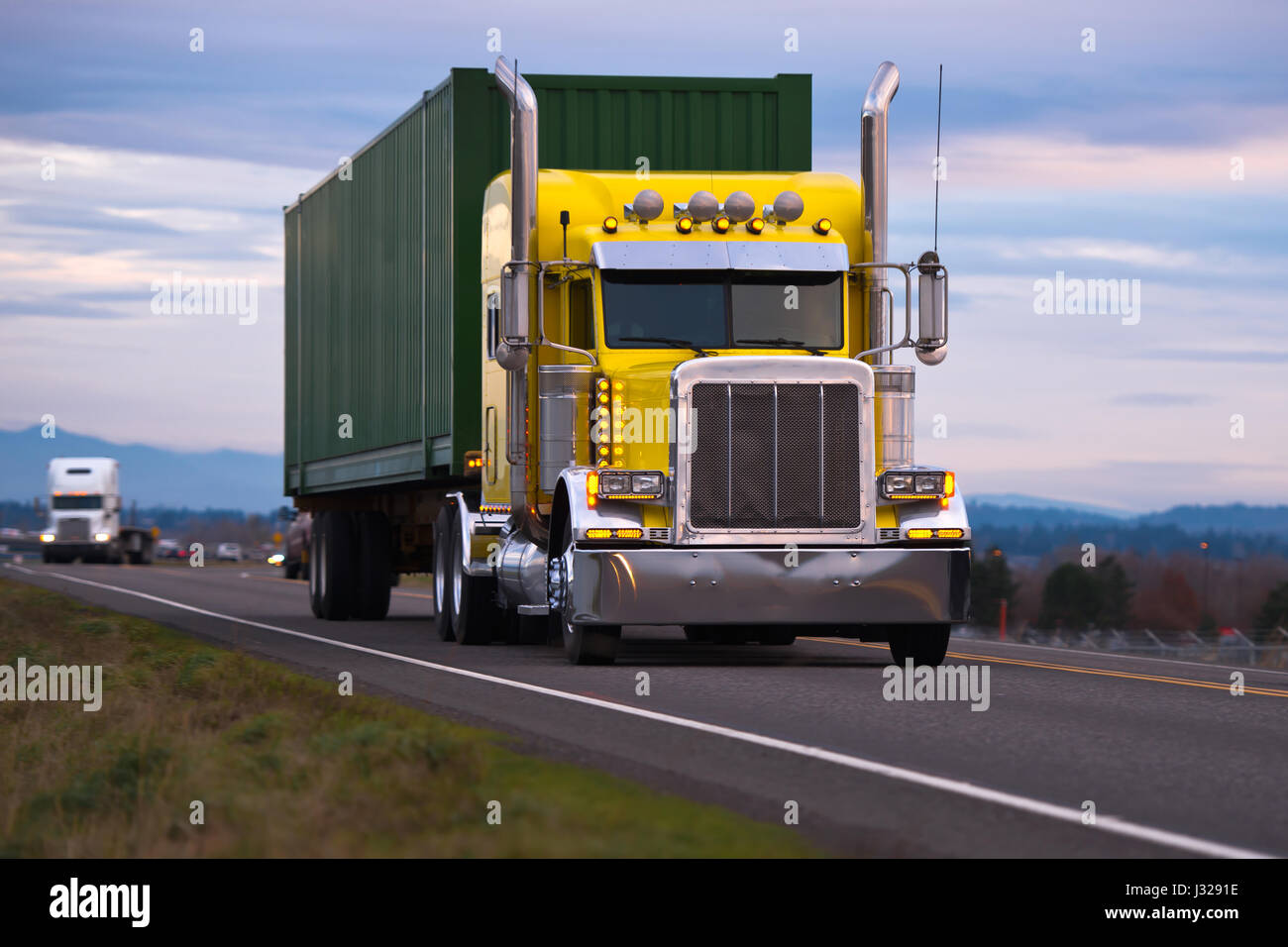 Classic American powerful yellow big rig semi truck with high chrome ...