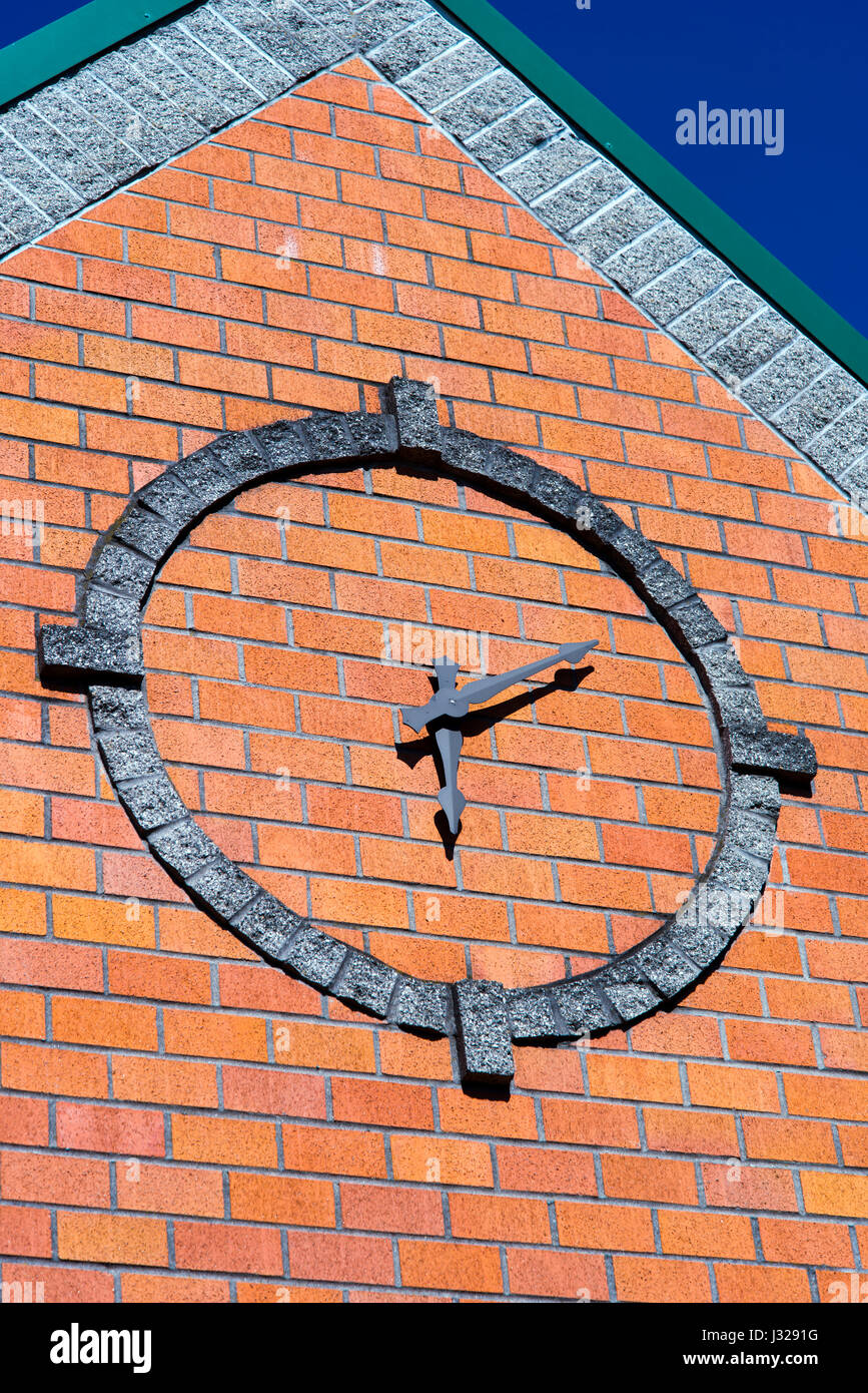 These stylized operating clock with arrows in a circle lined with stone ...