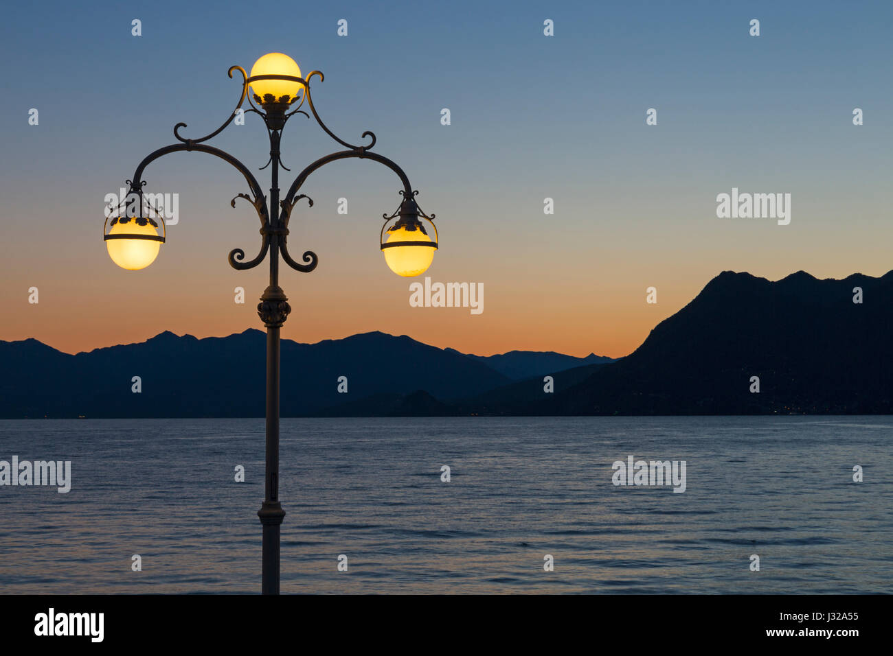 Ornate lamppost on lakeside promenade with stunning views at dawn at ...