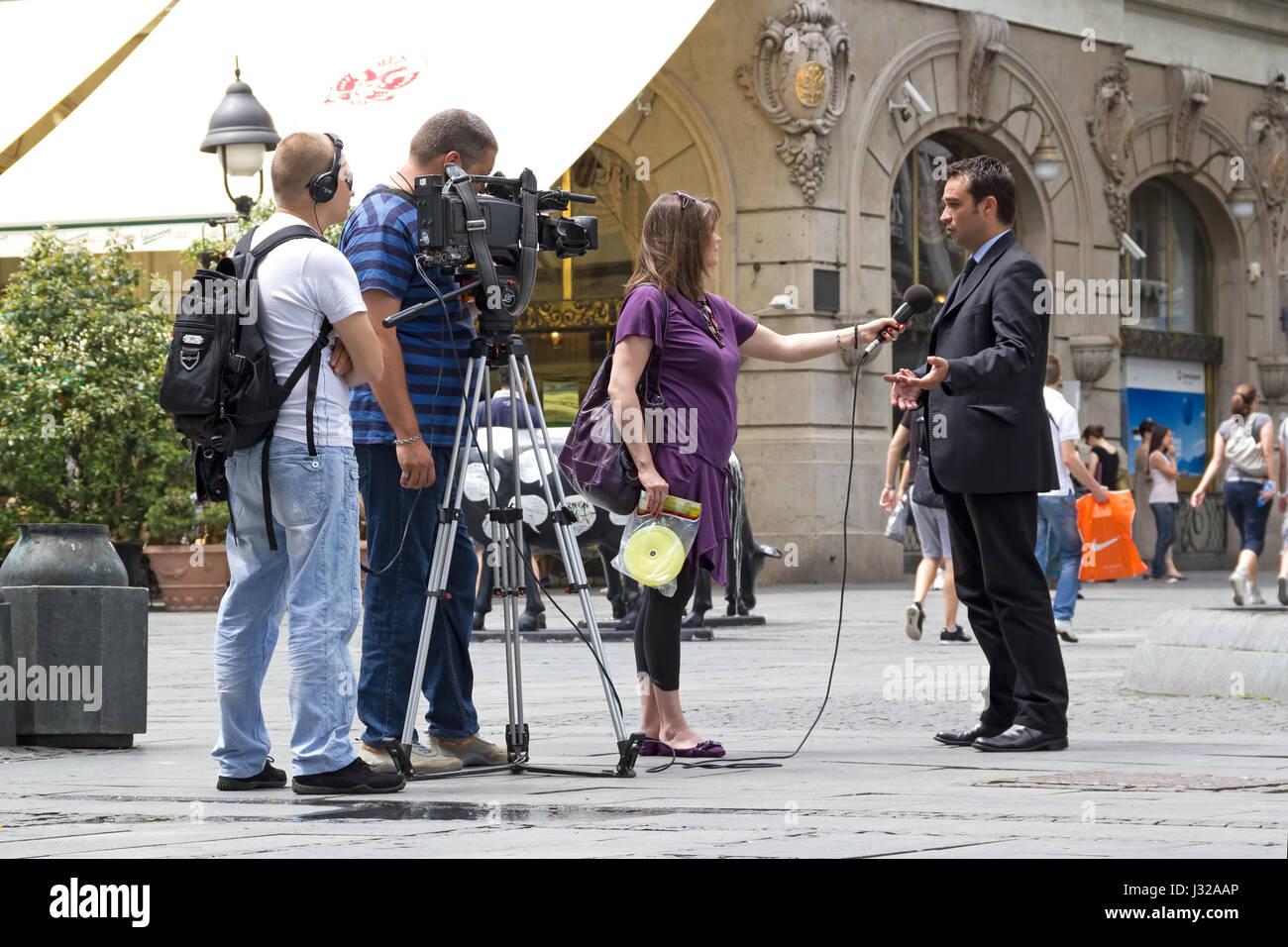 TV crew - Cameraman, sound recordist and TV reporter on the street ...