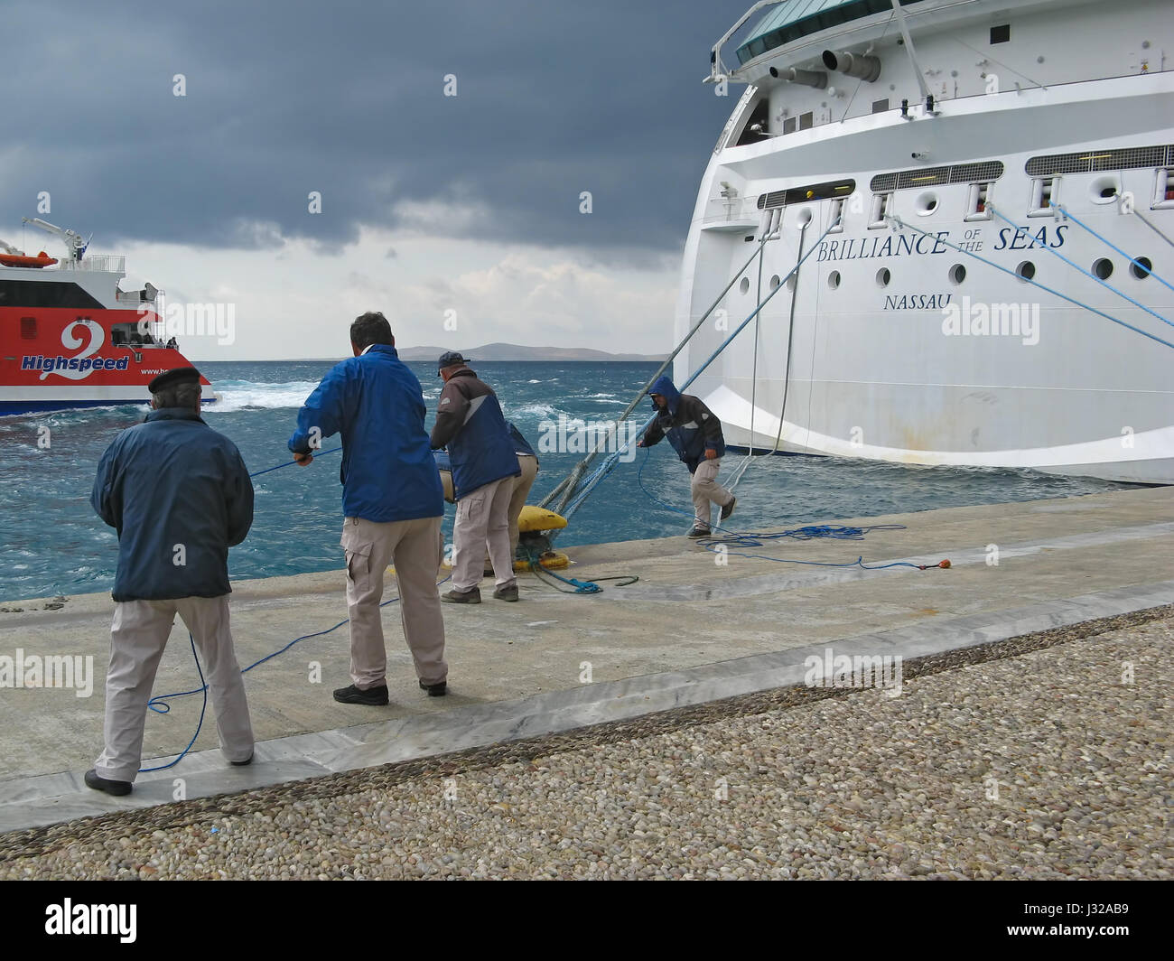 Cruiser workers - Group of people pulling the ropes of giant cruiser ...