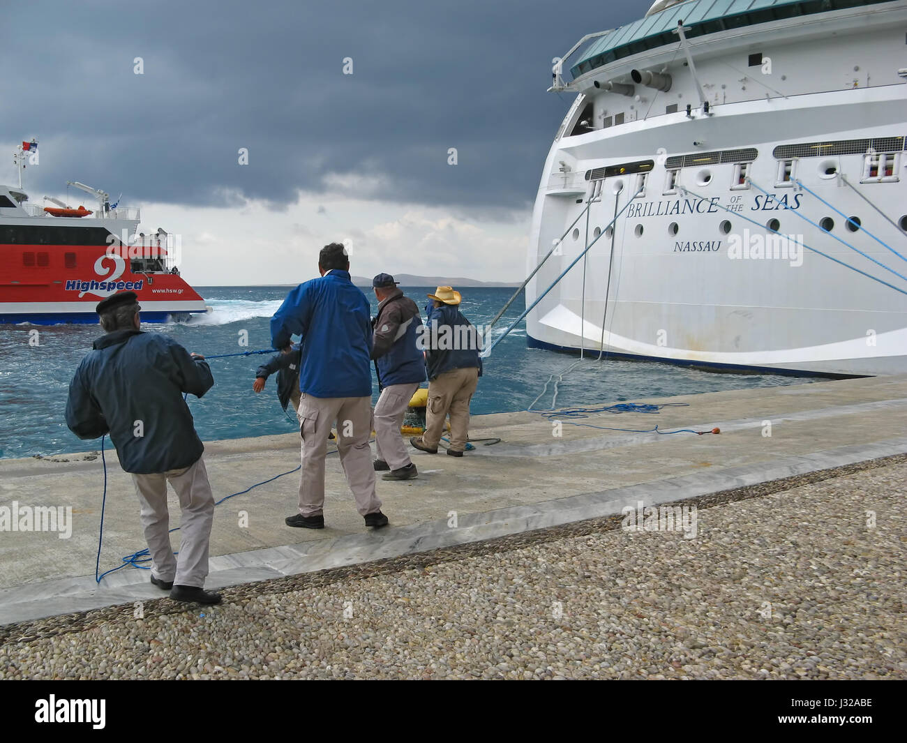 Cruiser workers in action - Group of people pulling the ropes of giant ...