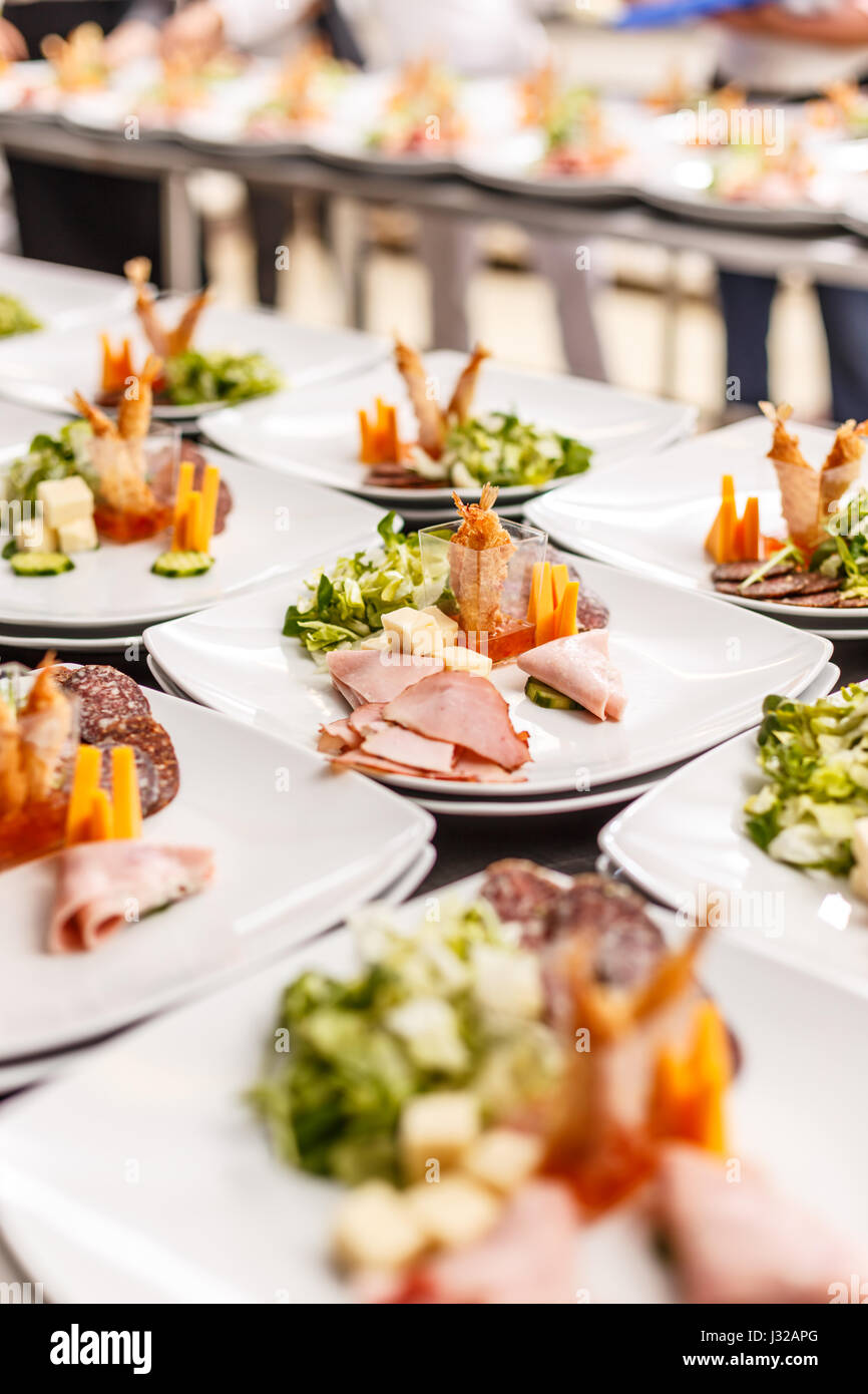 Catering table set service, lot of appetizers plate Stock Photo - Alamy