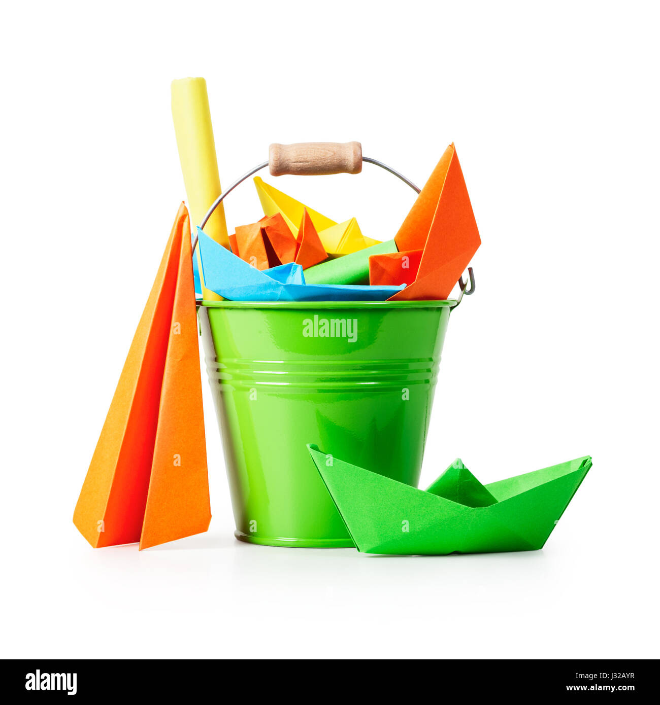 Green bucket with colorful paper sheets and origami toys isolated on ...