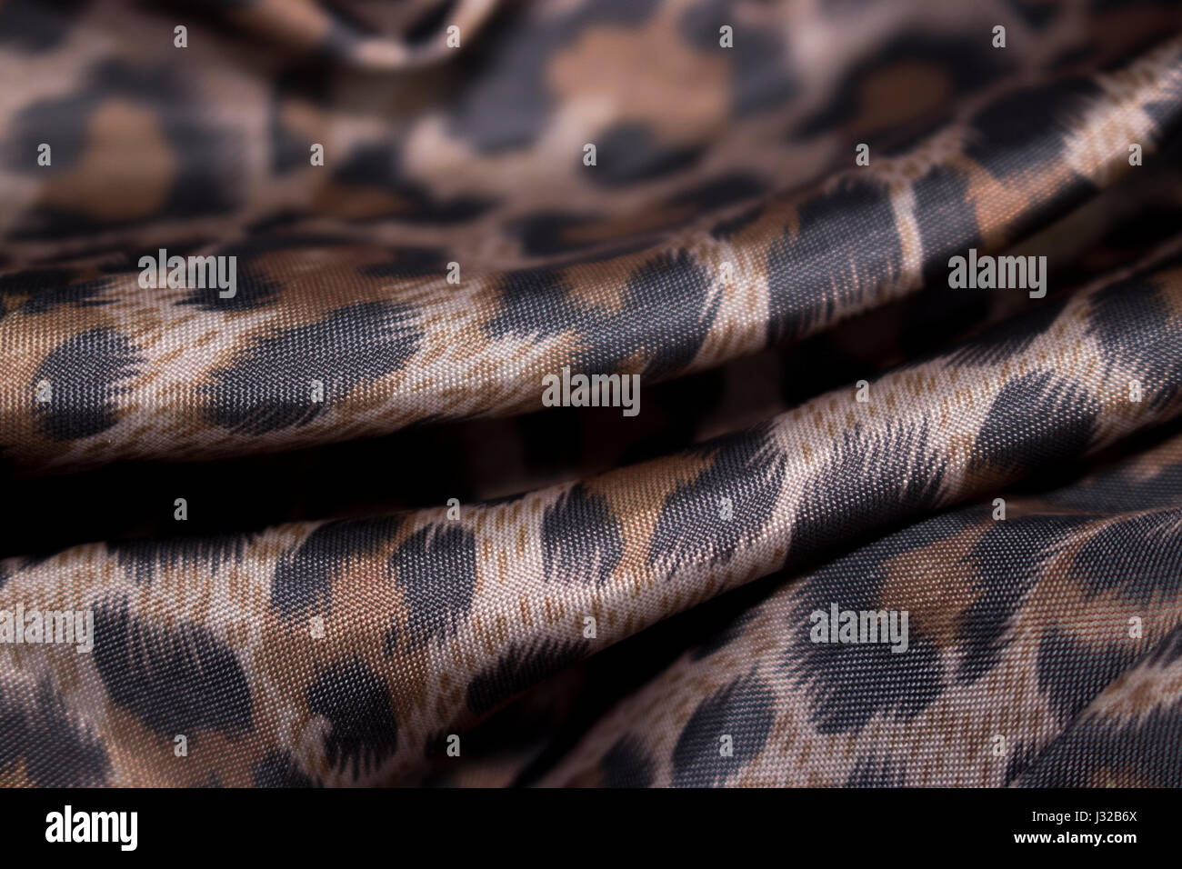 shiny leopard fabric cloth garment textile industry Stock Photo - Alamy