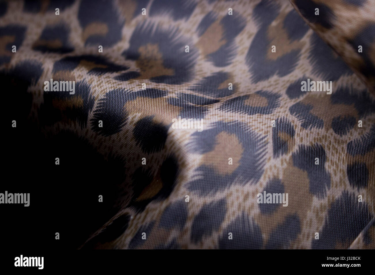 shiny leopard fabric cloth garment textile industry Stock Photo - Alamy