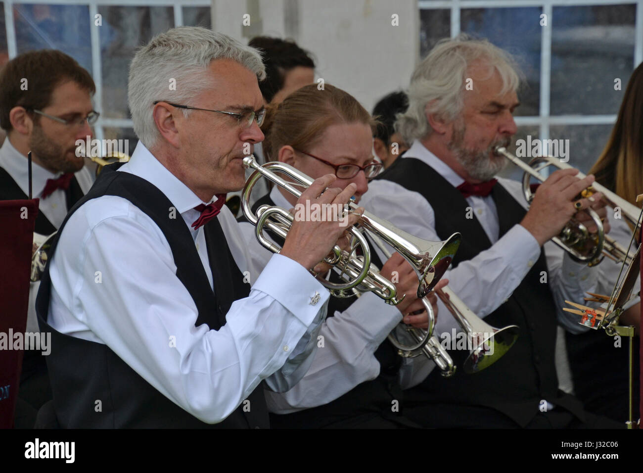 Men and a woman playing trumpets in a silver band at Longwick Village ...