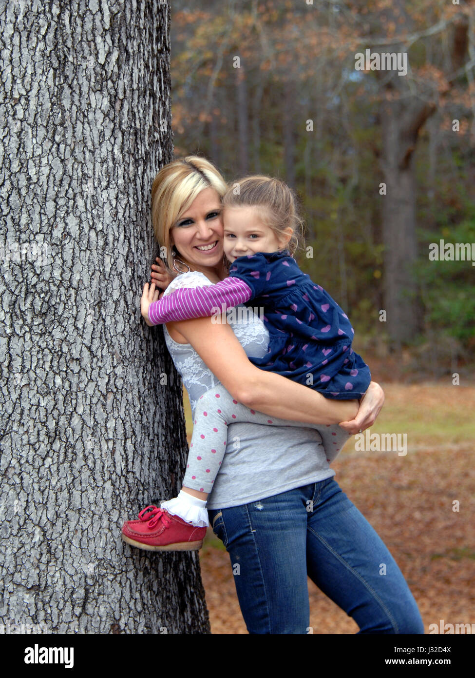 Play day outside includes hugs and affection and mother and daughter ...