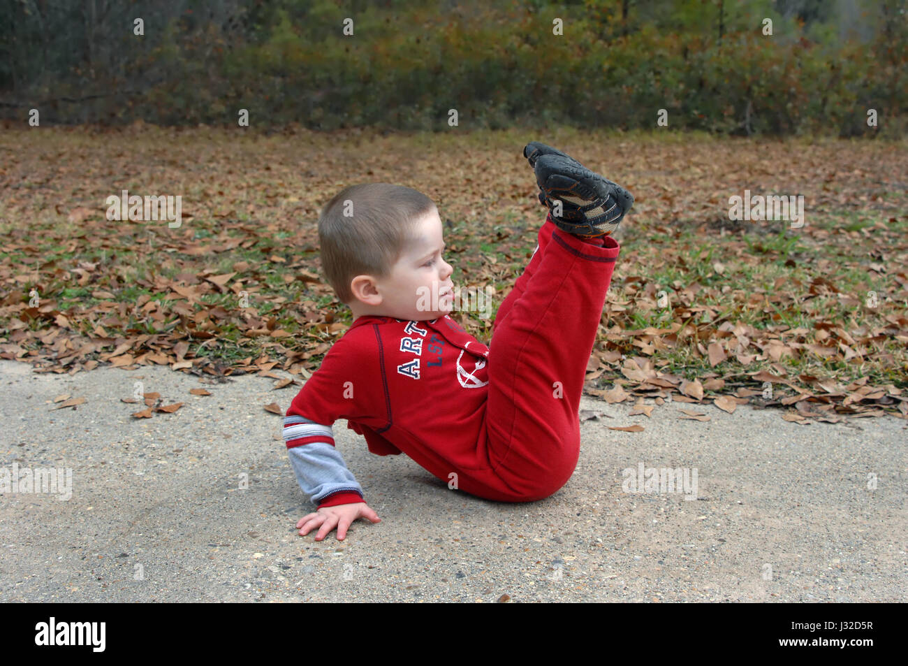 Little boy role plays the exercises he has seen his mom doing. He is ...