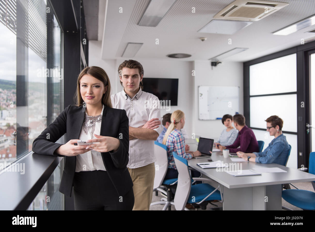 female manager using cell telephone in office interior Stock Photo - Alamy