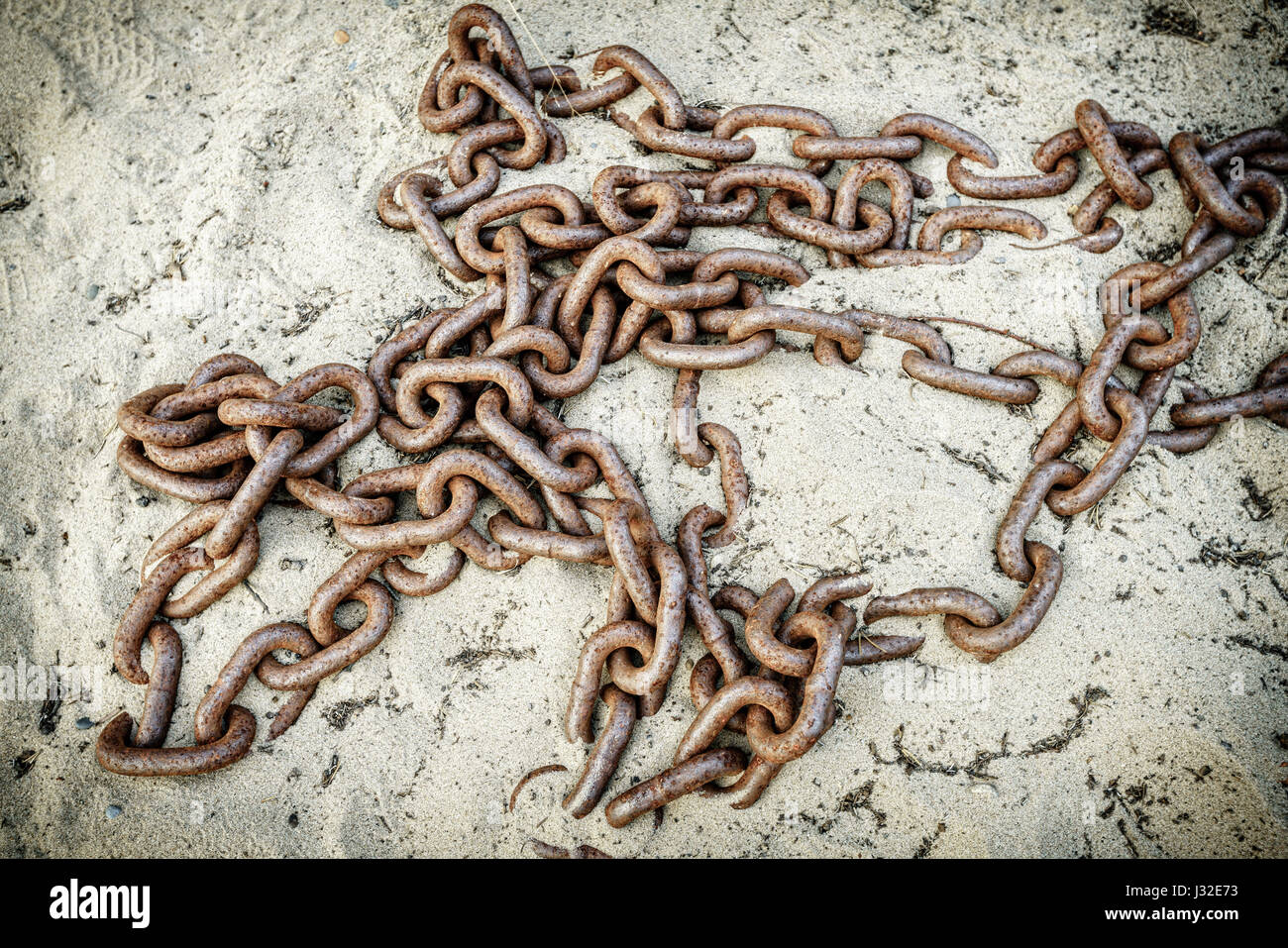 Old rusted chain in the sand on the beach of Lake Superior in Michigan ...