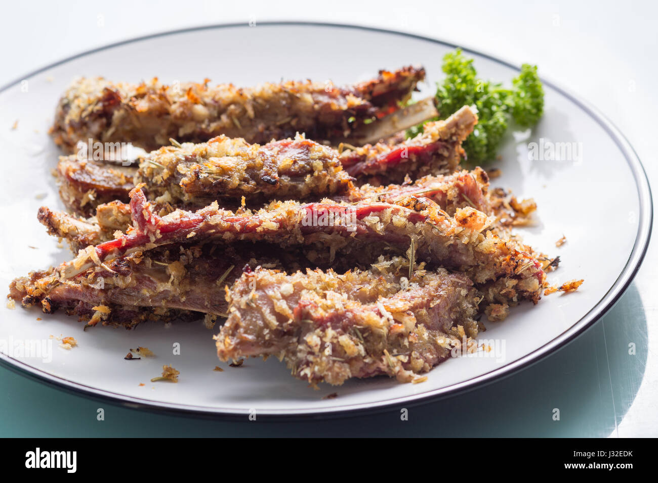 German style lamb chops on white plate Stock Photo - Alamy