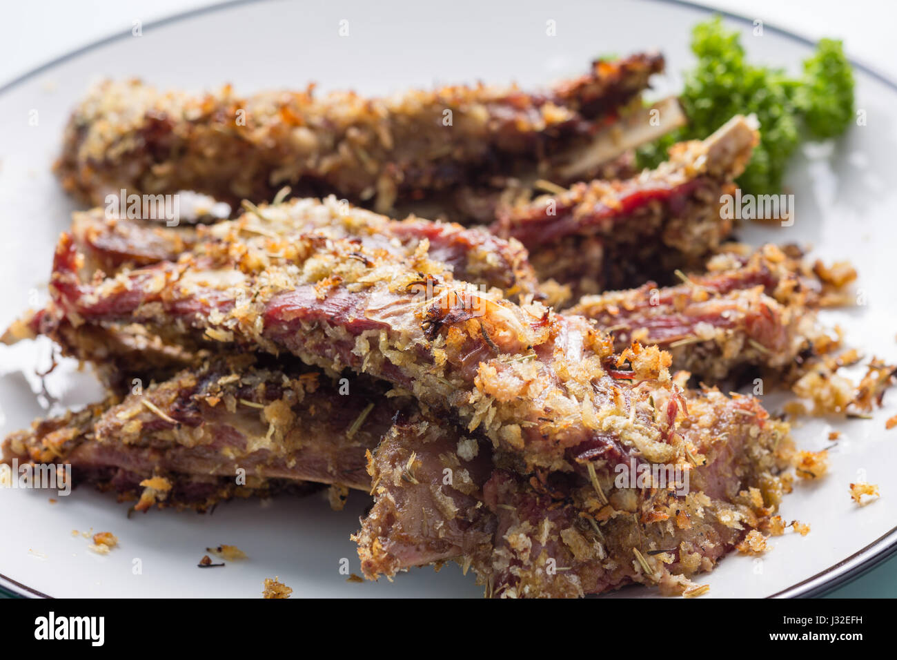German style lamb chops on white plate Stock Photo - Alamy