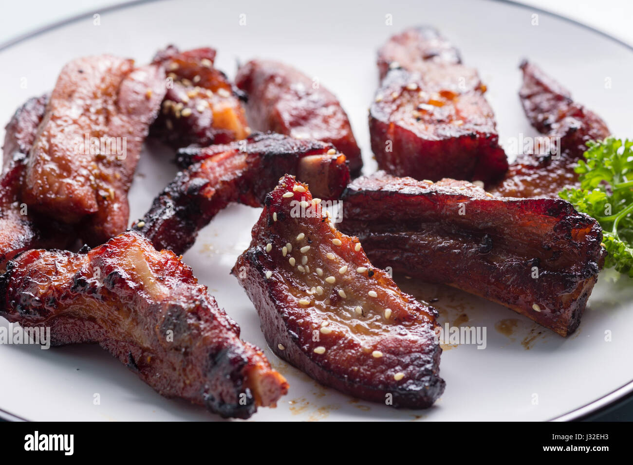 German style pork ribs on white plate Stock Photo - Alamy