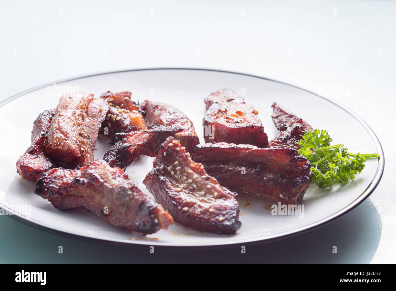 German style pork ribs on white plate Stock Photo - Alamy