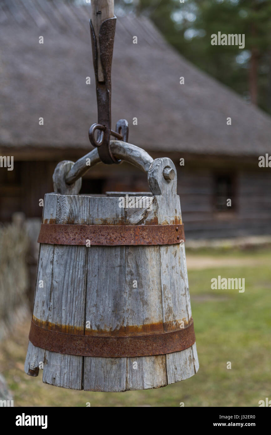 Traditional wooden country hut and well Stock Photo - Alamy