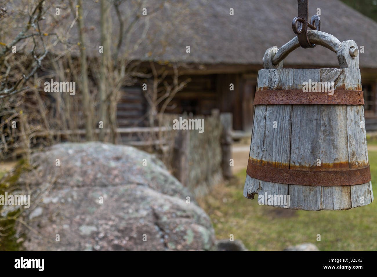 Traditional wooden country hut and well Stock Photo - Alamy