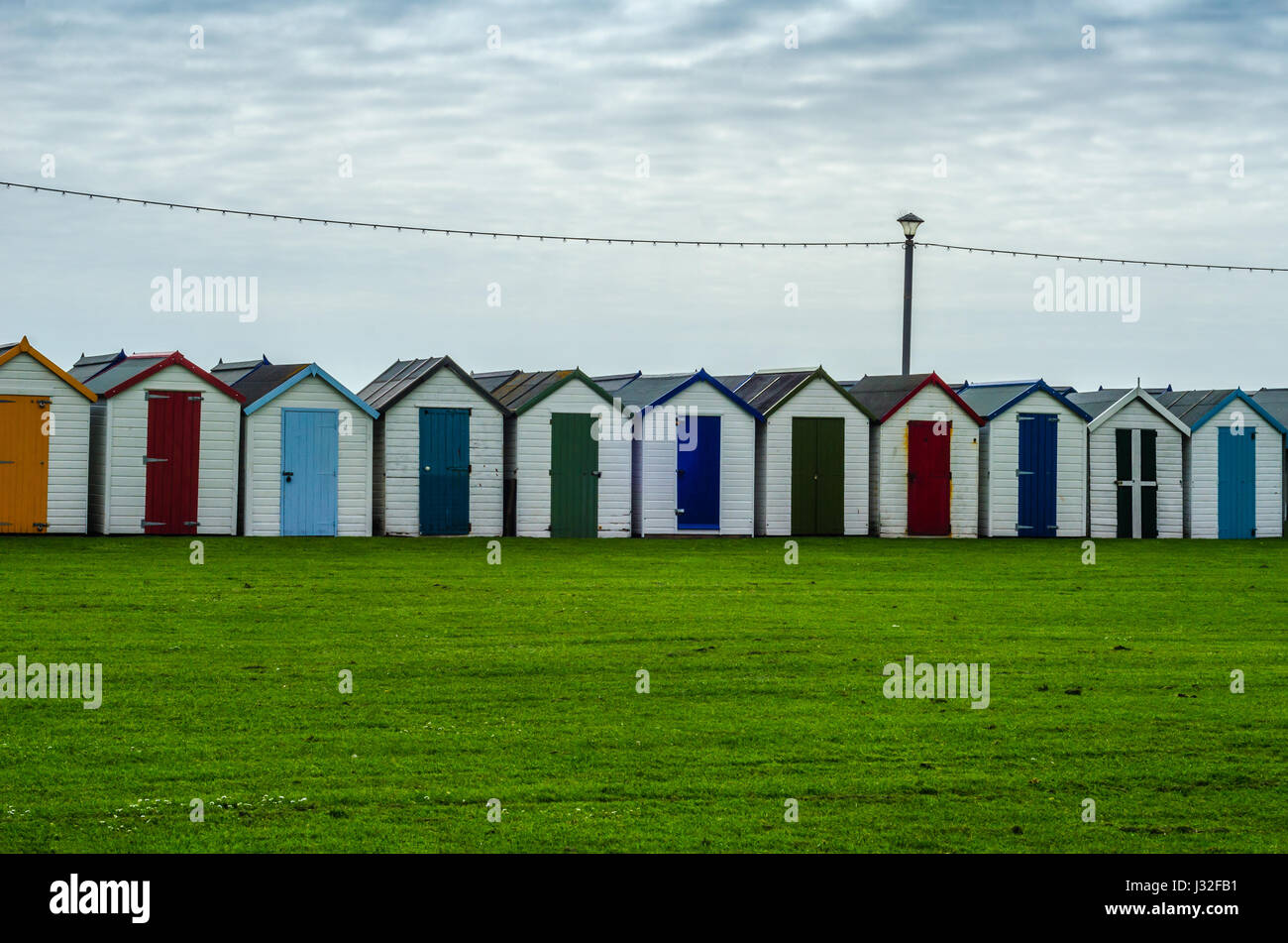 Colored houses on the beach, colorful door to summer cottages, seaside ...