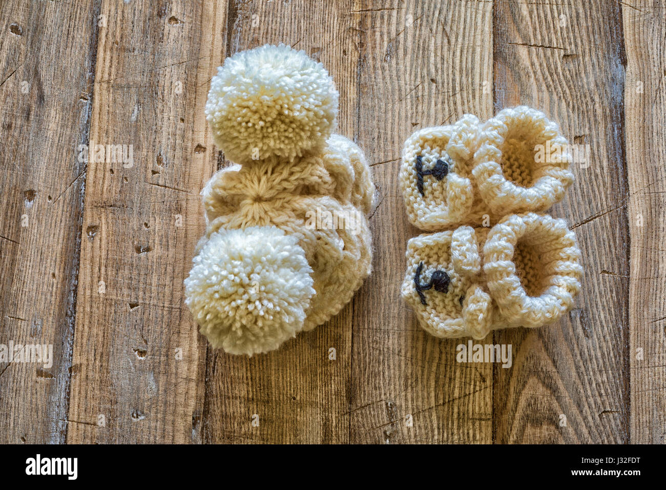 Baby clothes on a vintage wooden table Stock Photo - Alamy