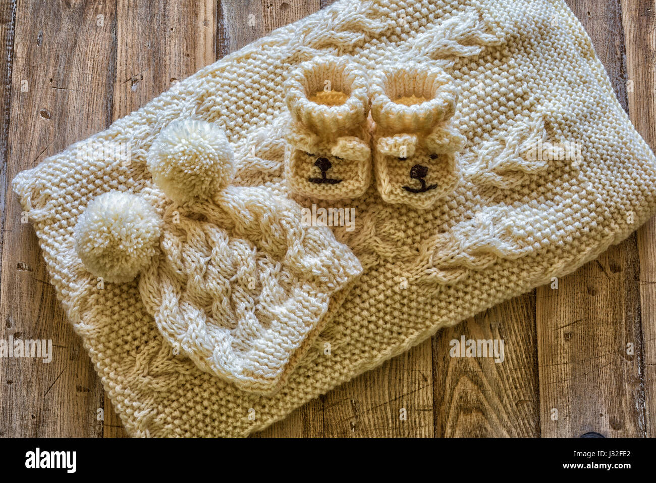 Baby clothes on a vintage wooden table Stock Photo - Alamy