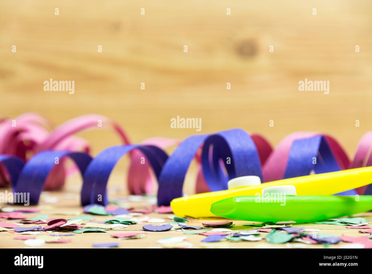 confetti, streamers and party whistle on wood background Stock Photo ...