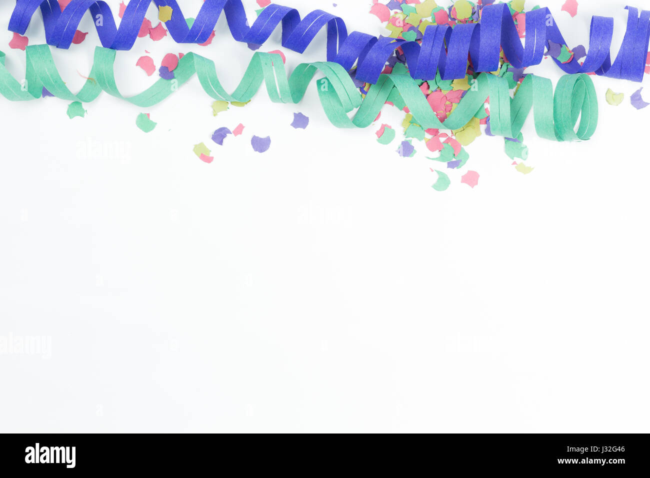 confetti and streamers on white background Stock Photo - Alamy