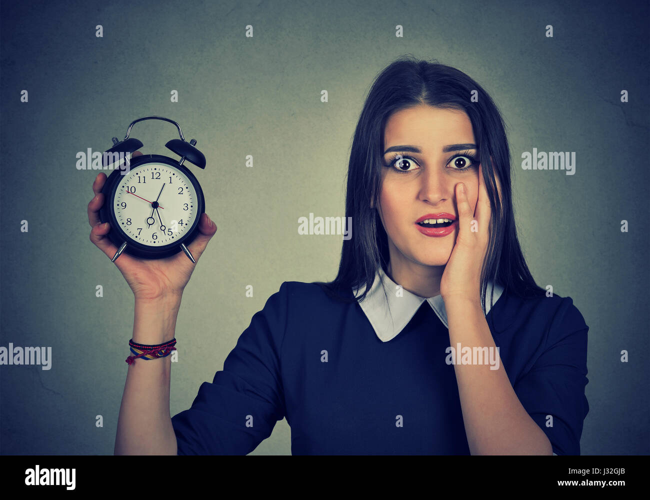 Anxious young woman with alarm clock. Time pressure concept. Human ...