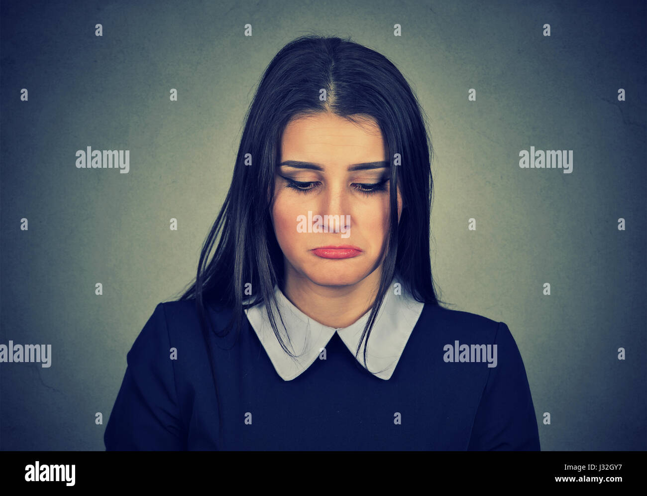 Portrait of a sad woman looking down Stock Photo - Alamy
