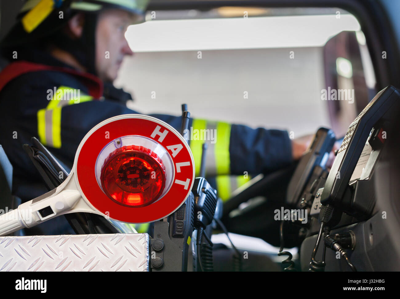 Firefighter drives a emergency vehicle with communication interior view ...