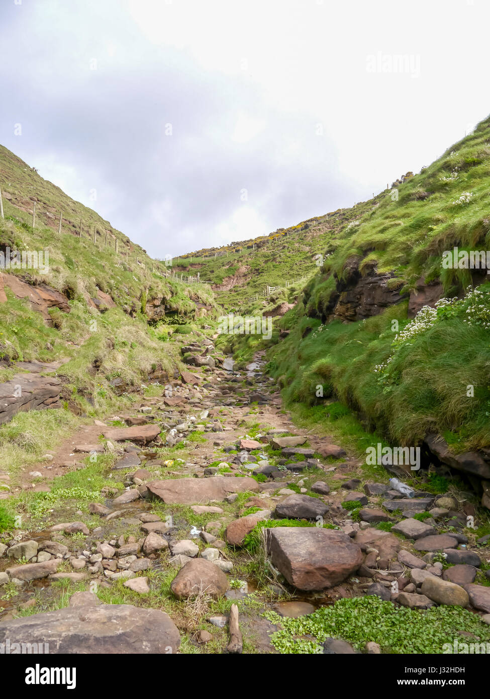 The footpath through the gully onto the beach at Fleswick Bay, Cumbria ...