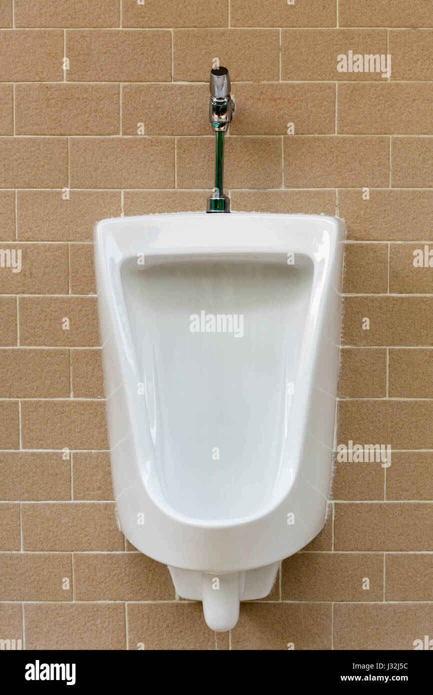 White urinal for men on brick wall in public toilet Stock Photo - Alamy