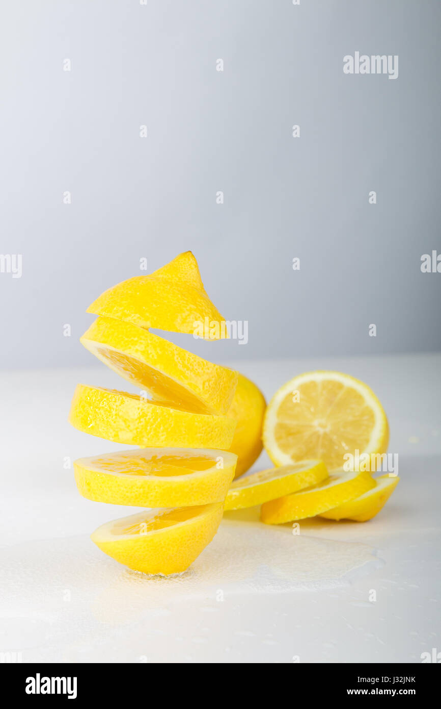 Flying lemon. Sliced lemon on white background. Levity fruit floating ...