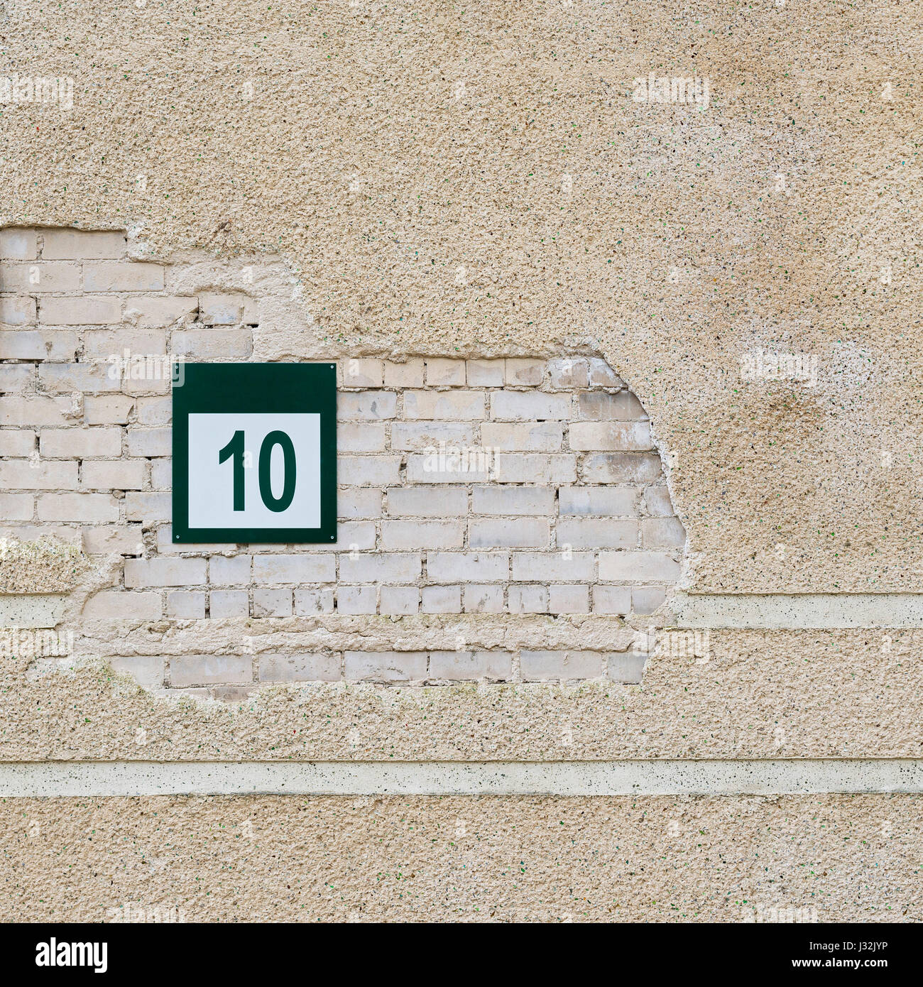 cracked brick wall and plate with a number ten Stock Photo - Alamy