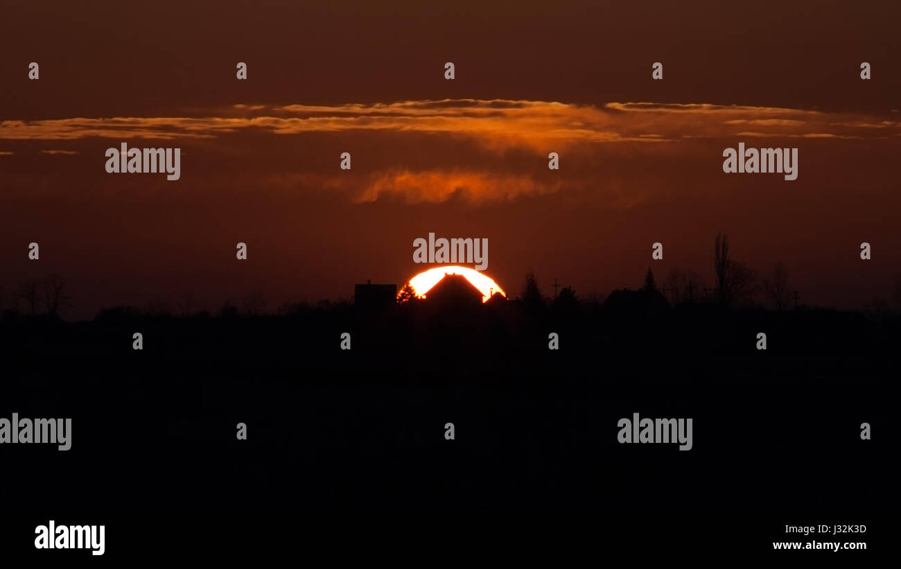 House Of The Falling Sun - Sunset behind distant house silhouette on ...