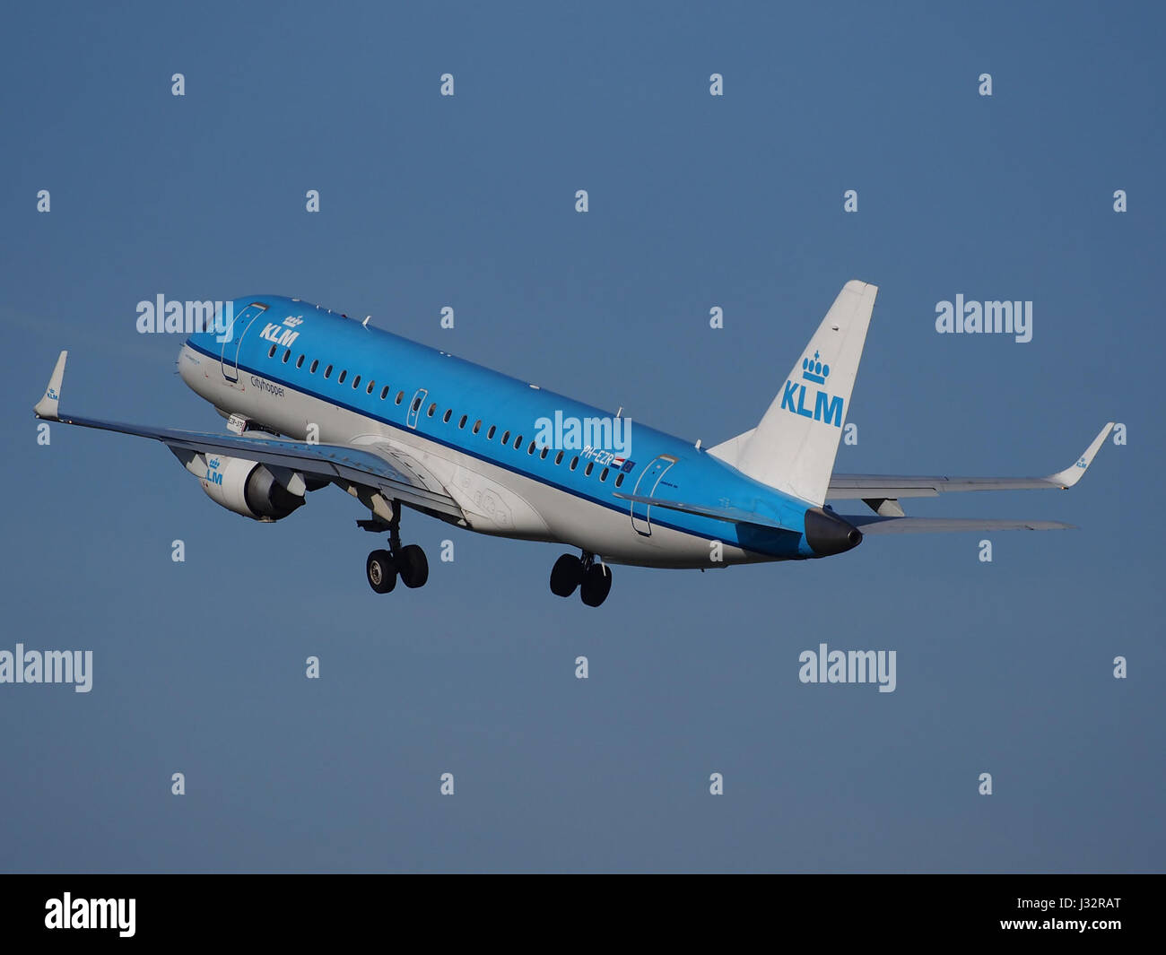 The photo shows a KLM Cityhopper Embraer ERJ-190STD taking off from ...