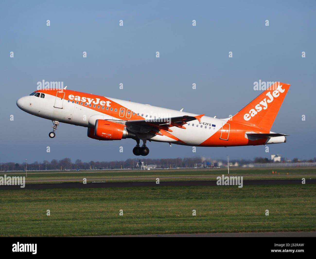 The image shows an easyJet Airbus A319-111, tail number G-EZFO, taking ...