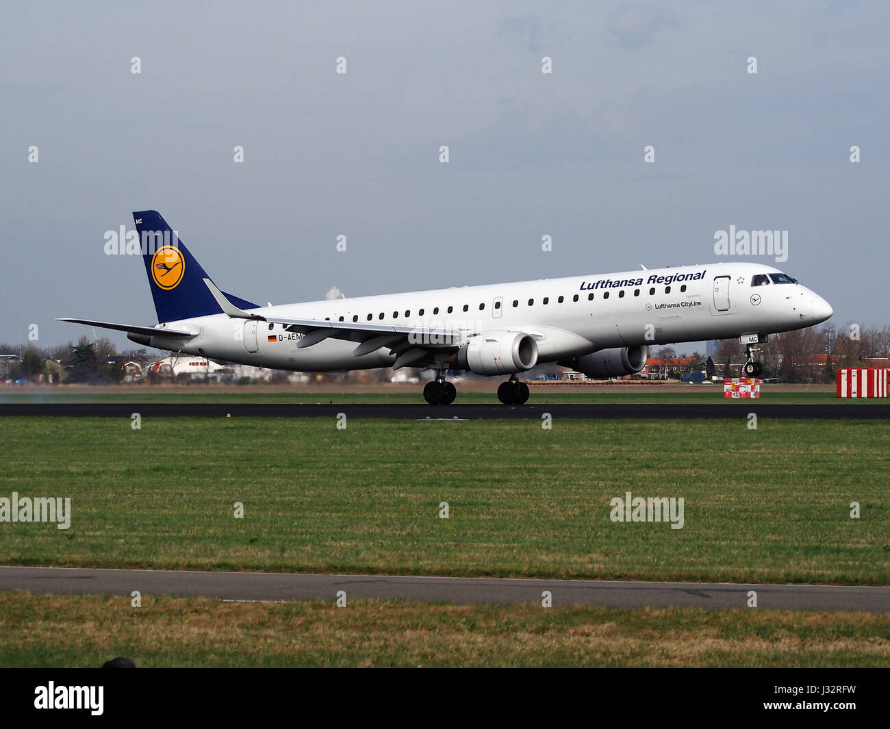 The image captures a Lufthansa CityLine Embraer ERJ-195LR aircraft ...