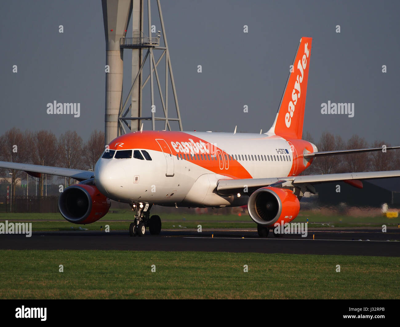 The easyJet Airbus A319-111, registration G-EZFZ, is captured at ...